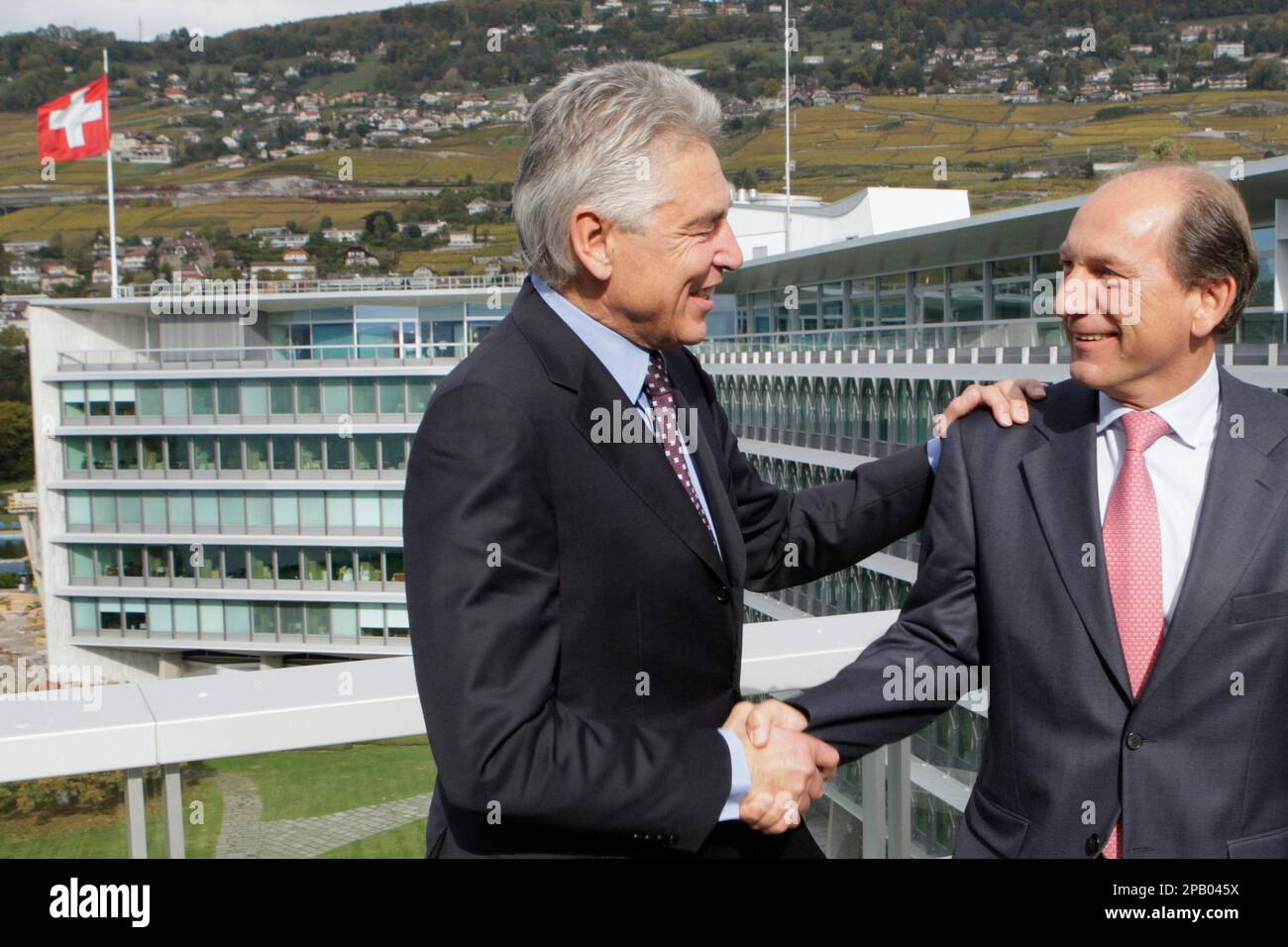 Nestle's Chairman and CEO Peter Brabeck-Letmathe, left, shakes hands ...