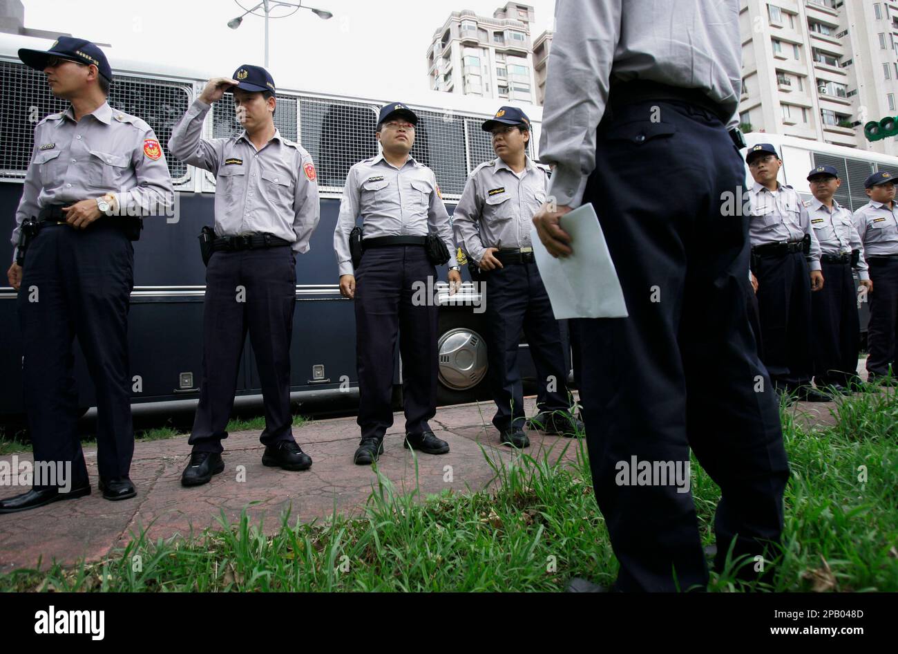 Taipei police officers secure the surroundings of a mass memorial in honor of the late Chen Chi ...