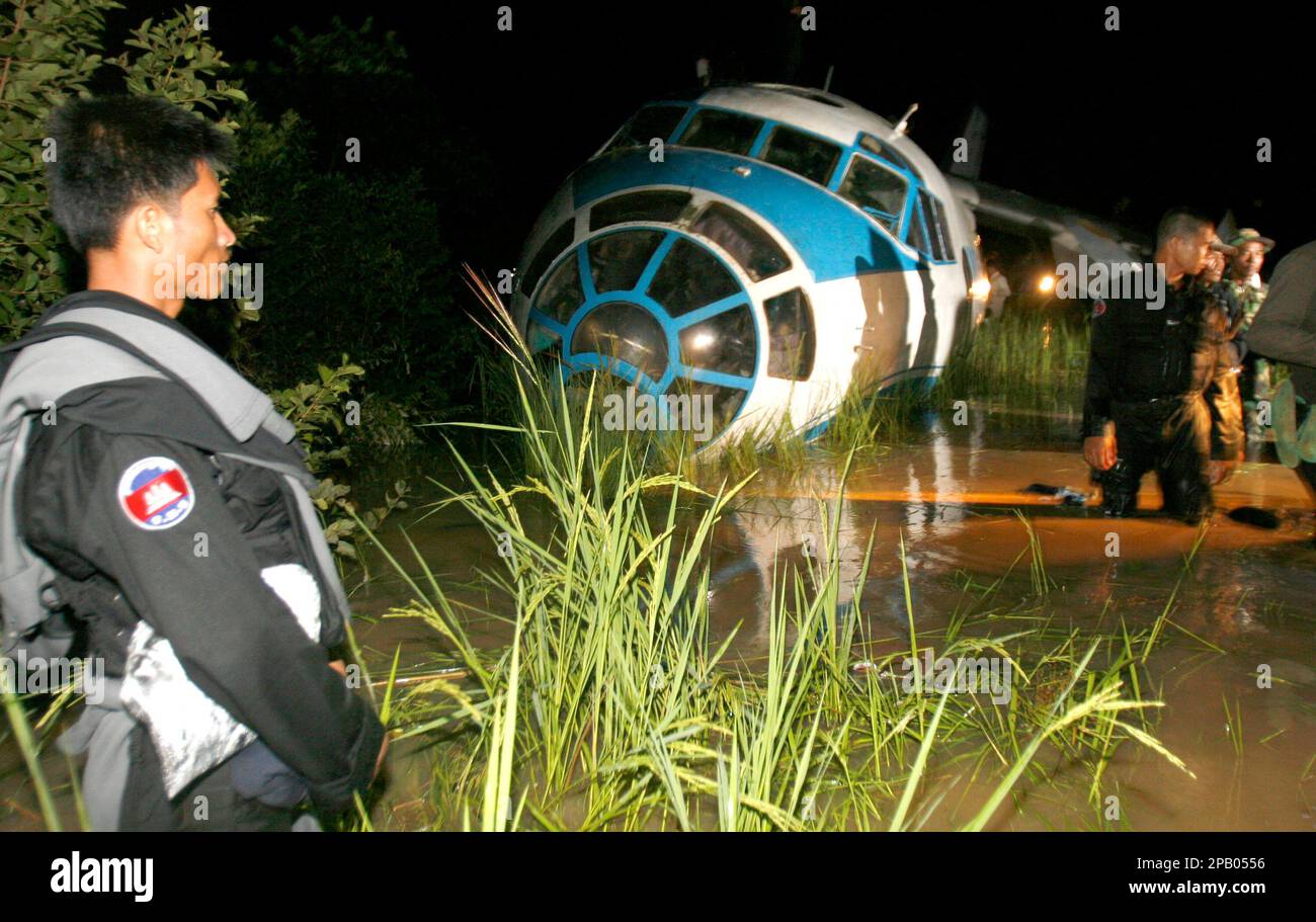 A Cambodian army soldier stands near the plane which crashed near Phnom ...