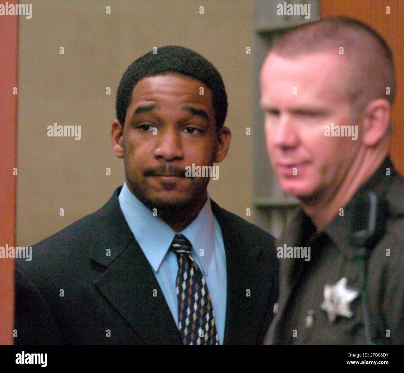 Orange Taylor III, left, is led into the courtroom for his murder trial ...