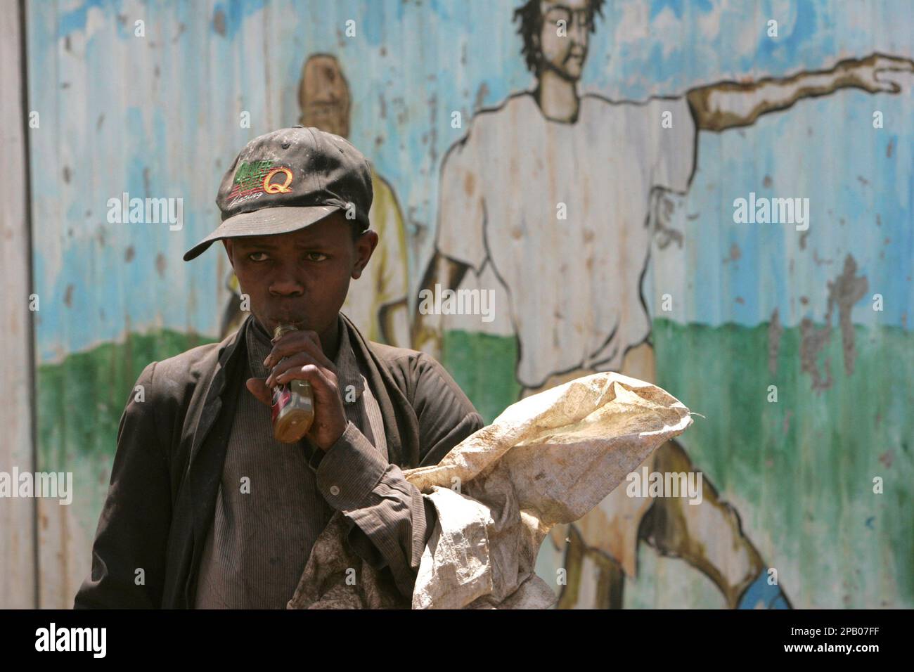 A Kenyan homeless child inhales glue, Wednesday, Oct. 17, 2007 at the ...