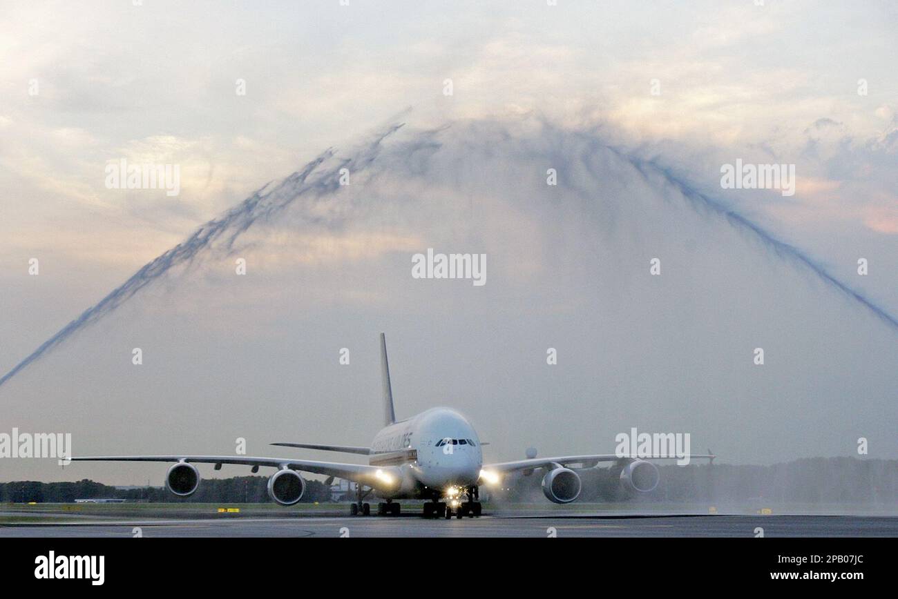 Fire engines welcome the Airbus A380 by spraying water over it at the ...