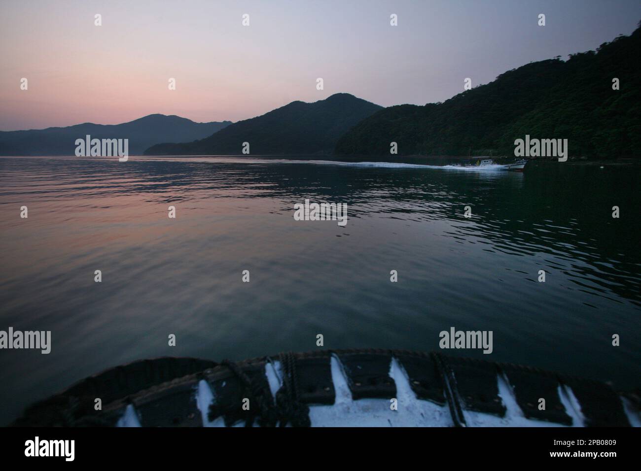 Fishing boats ply the waters of Shiranui Sea near Minamata, Japan on ...