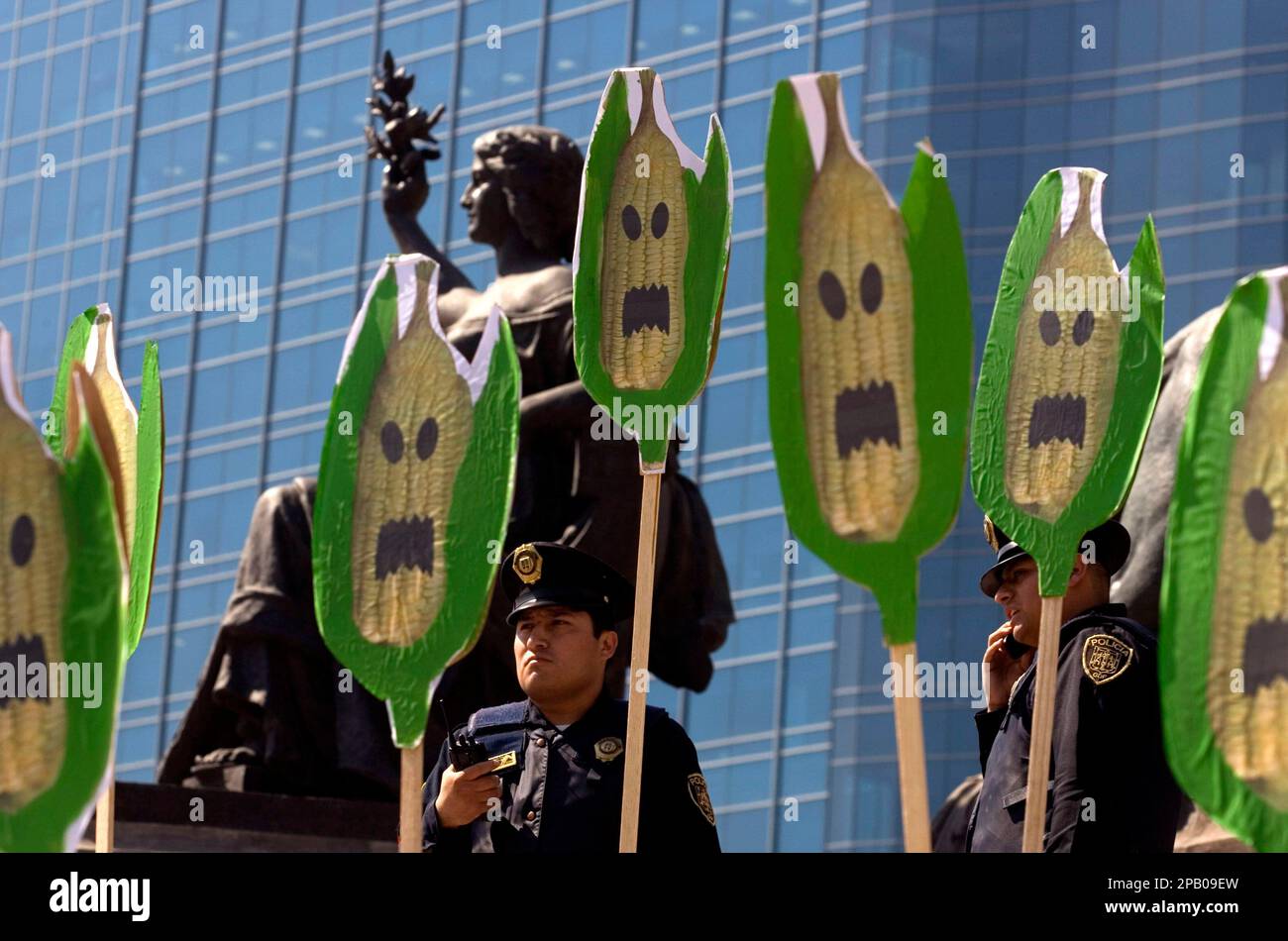 Police officers stand as Greenpeace activists protest against the ...