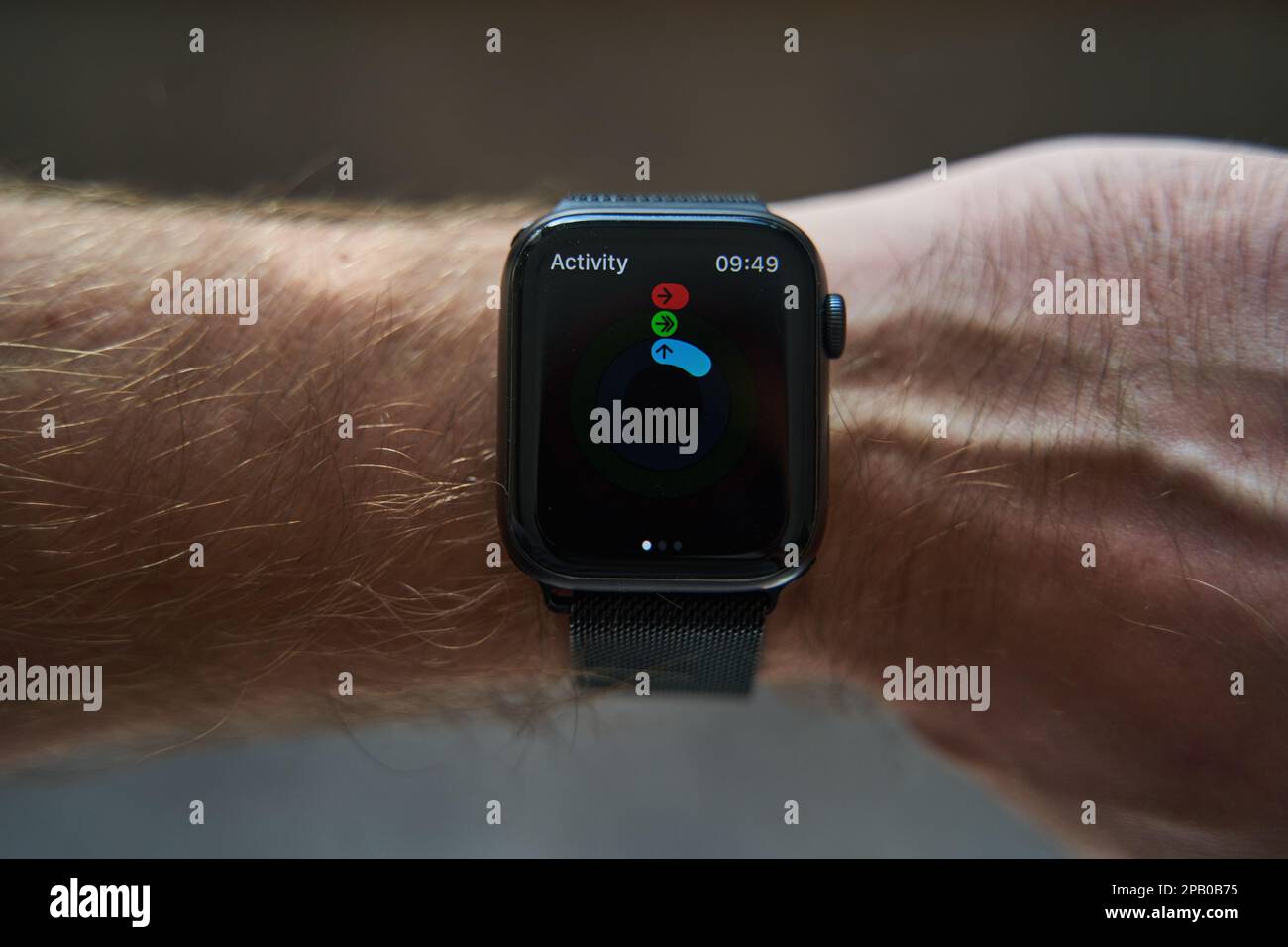 A square smartwatch on a man's hand close up. Activity rings on the ...