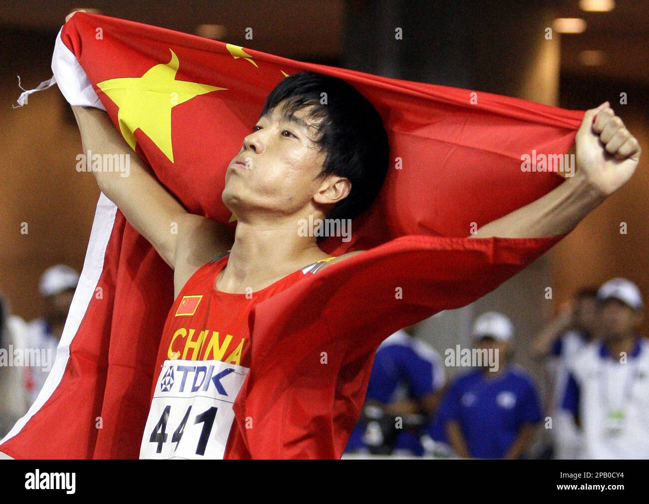 ** FILE ** China's Liu Xiang celebrates with a Chinese flag after ...