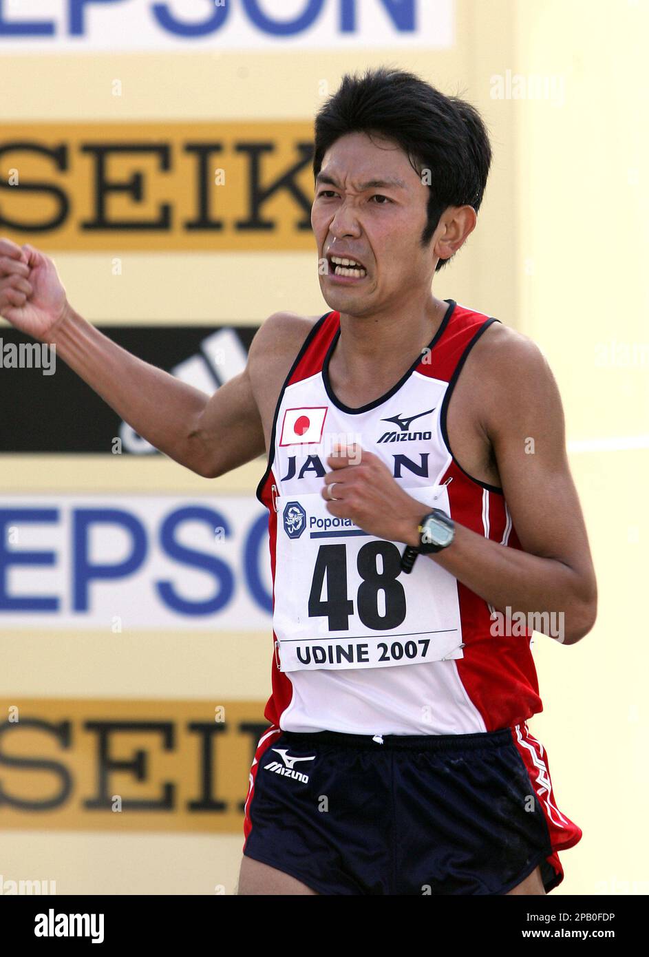 Japan's Atsushi Sato reacts as he crosses the finish line of the men's half-marathon, at the ...