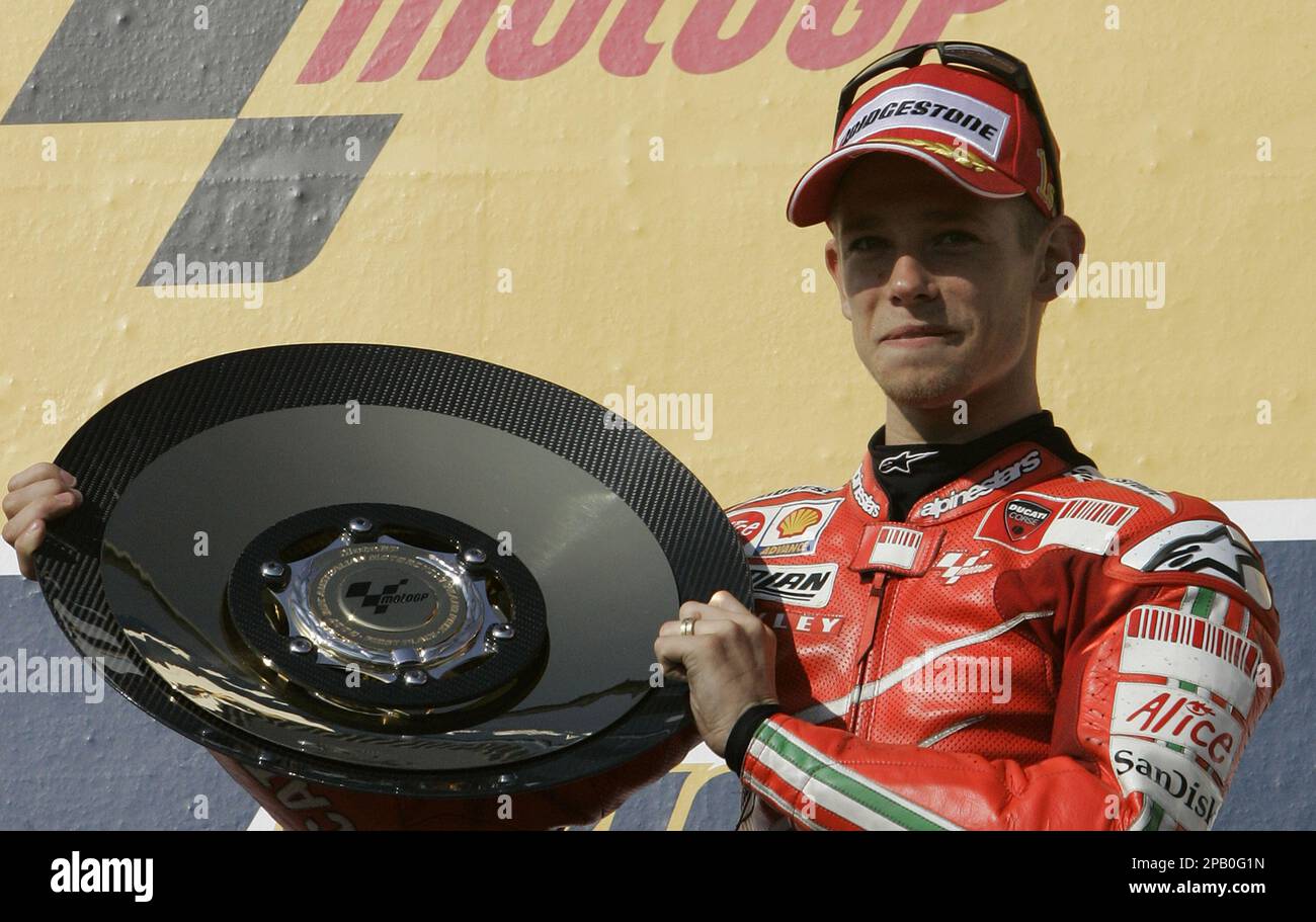 Australian world champion Casey Stoner holds the winner's trophy after ...