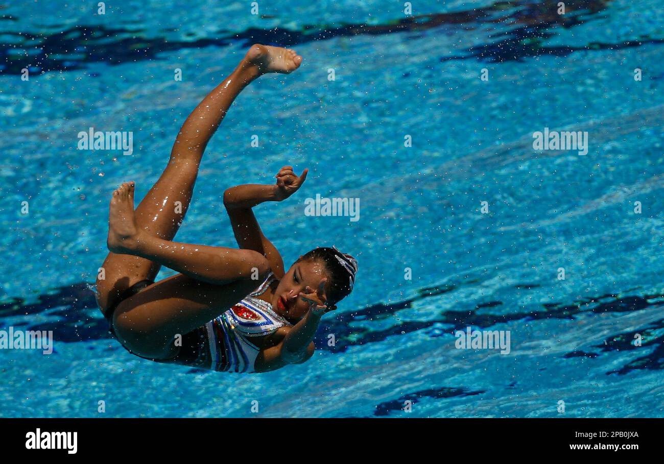A member of Japan's synchronized swimming team performs during their ...