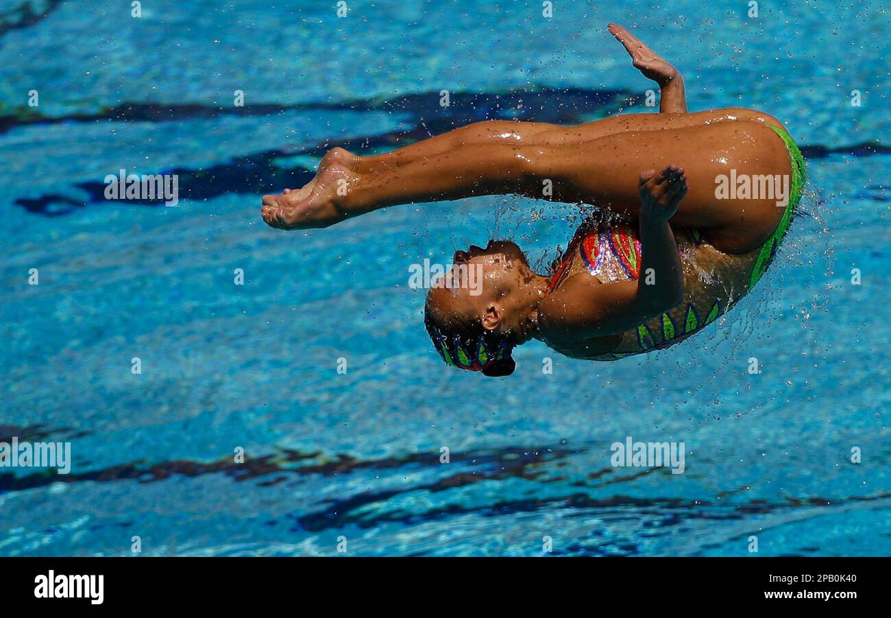 A member of Russia's synchronized swimming team performs during her ...