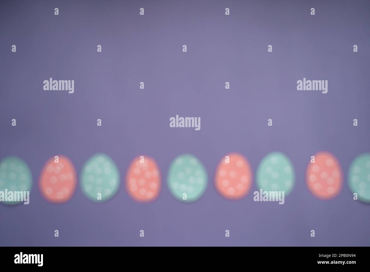 Decorated paper easter eggs and copy space for text on colored ...