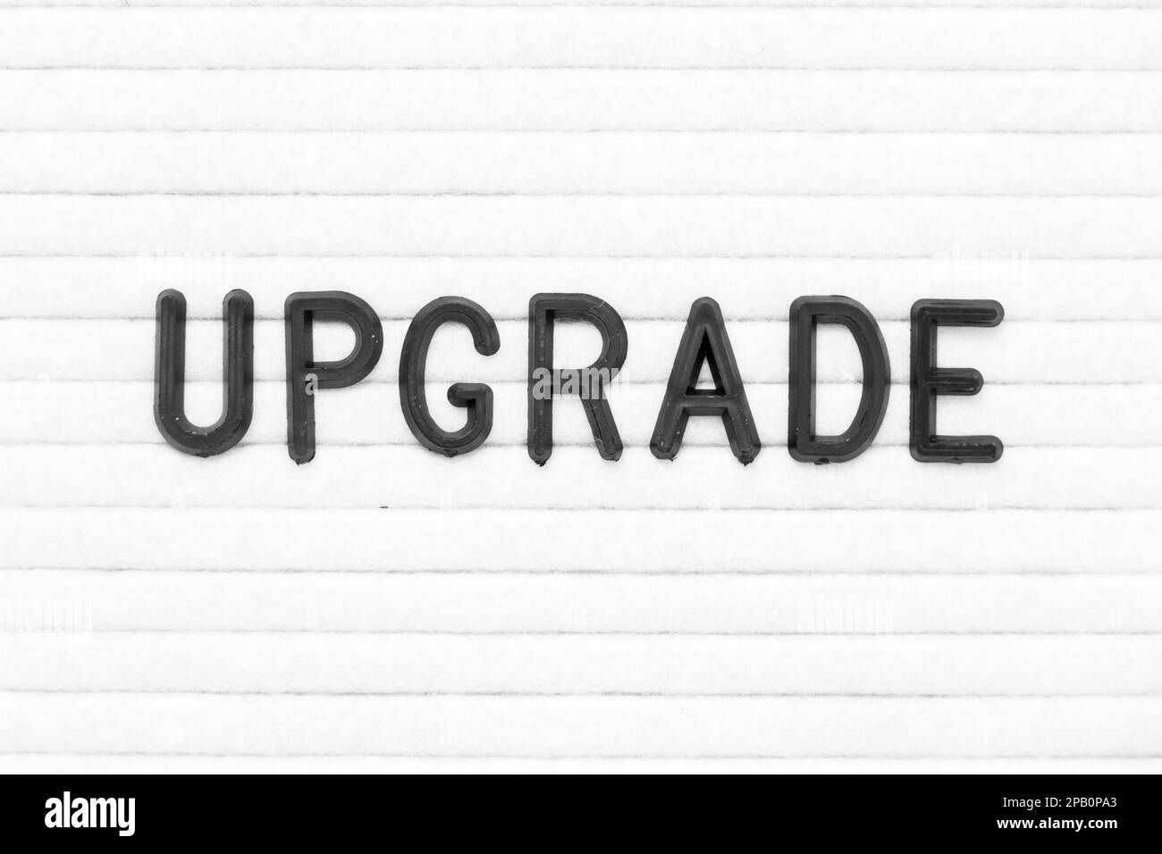 Black color letter in word upgrade on white felt board background Stock ...