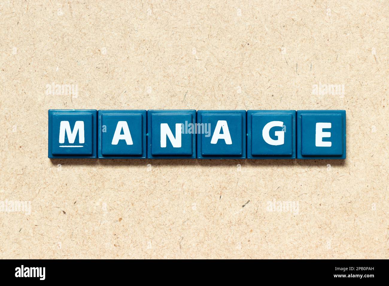 Tile alphabet letter in word manage on wood background Stock Photo - Alamy