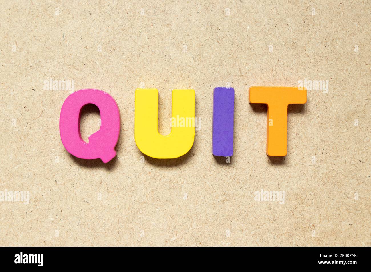 Color alphabet letter in word quit on wood background Stock Photo - Alamy