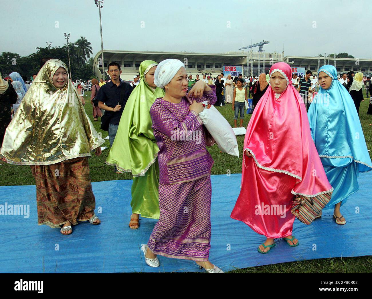 A mother accompanies her four daughters dressed in traditional Muslim ...