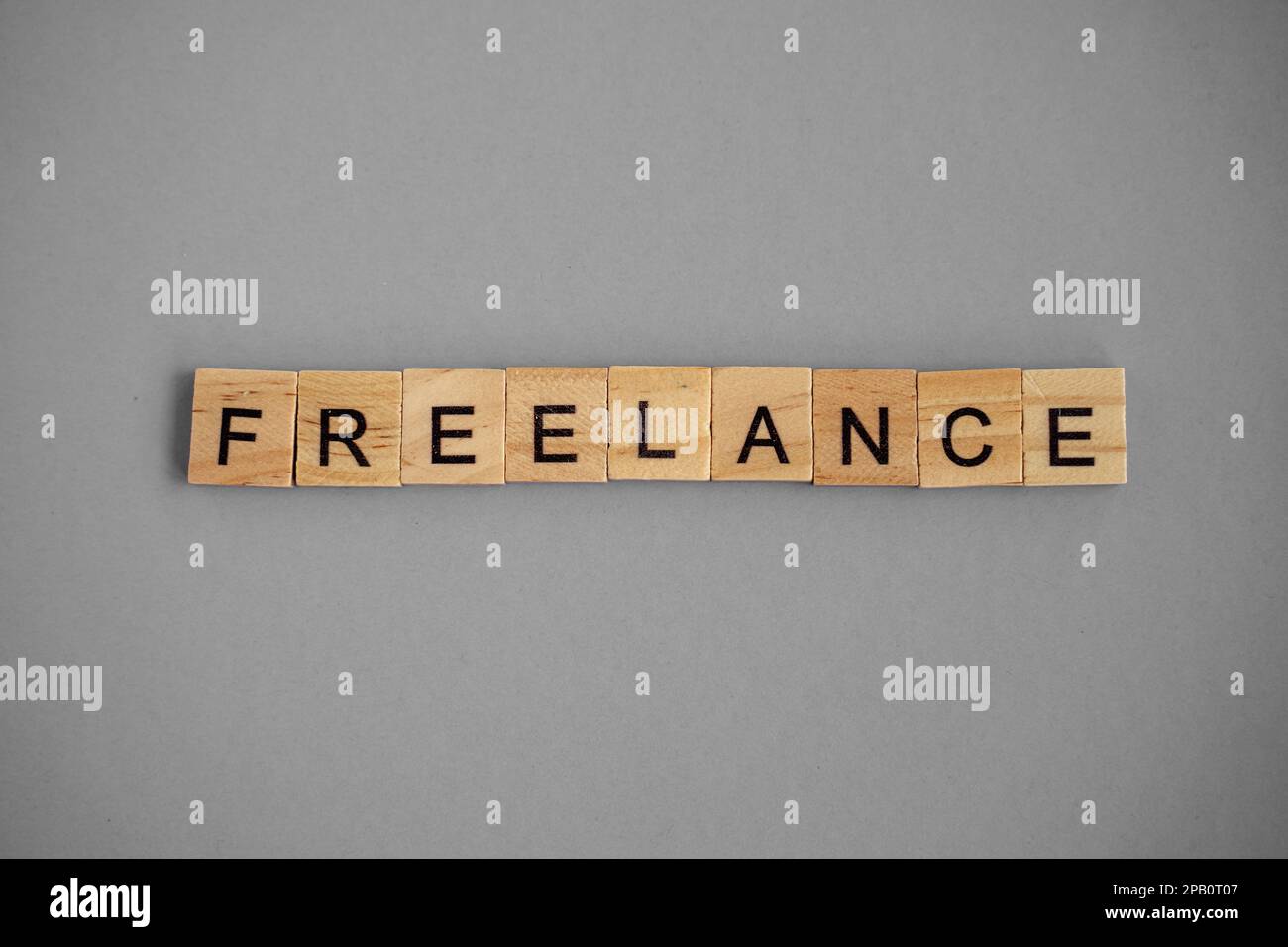 Word freelance. Wooden blocks with lettering on top of gray background ...
