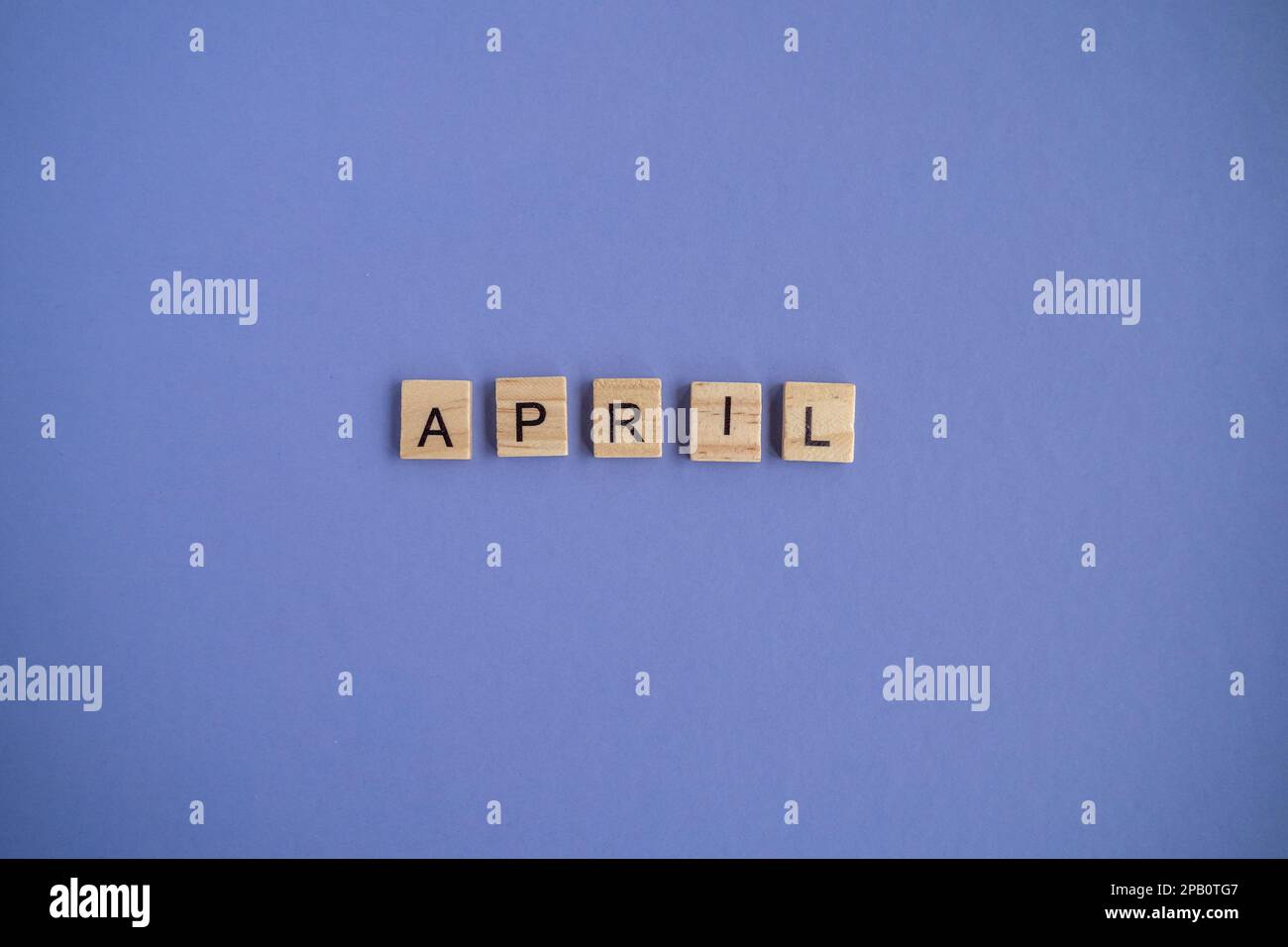 April month name written on wooden isolated cubes. Very Peri Top view ...