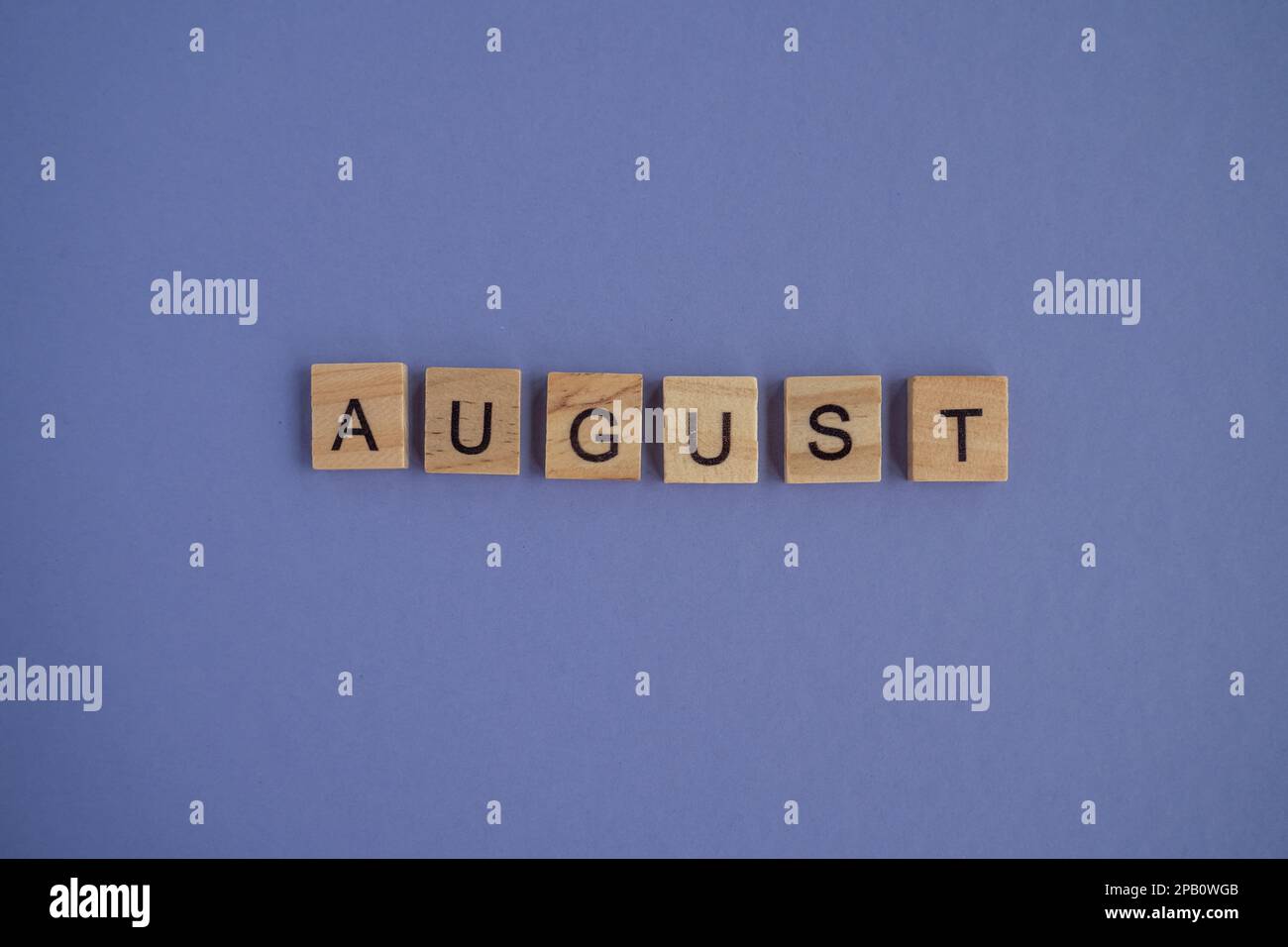 The name of the month August is written on wooden cubes isolated. Top ...