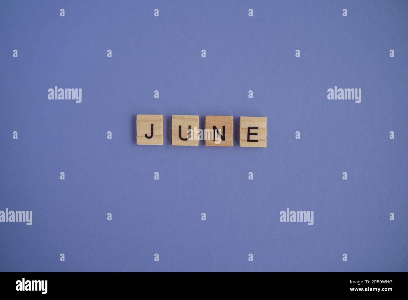 The name of the month of June is written on wooden cubes isolated. Top ...