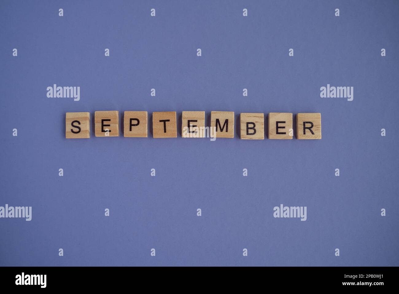 The name of the month of September is written on wooden cubes isolated ...