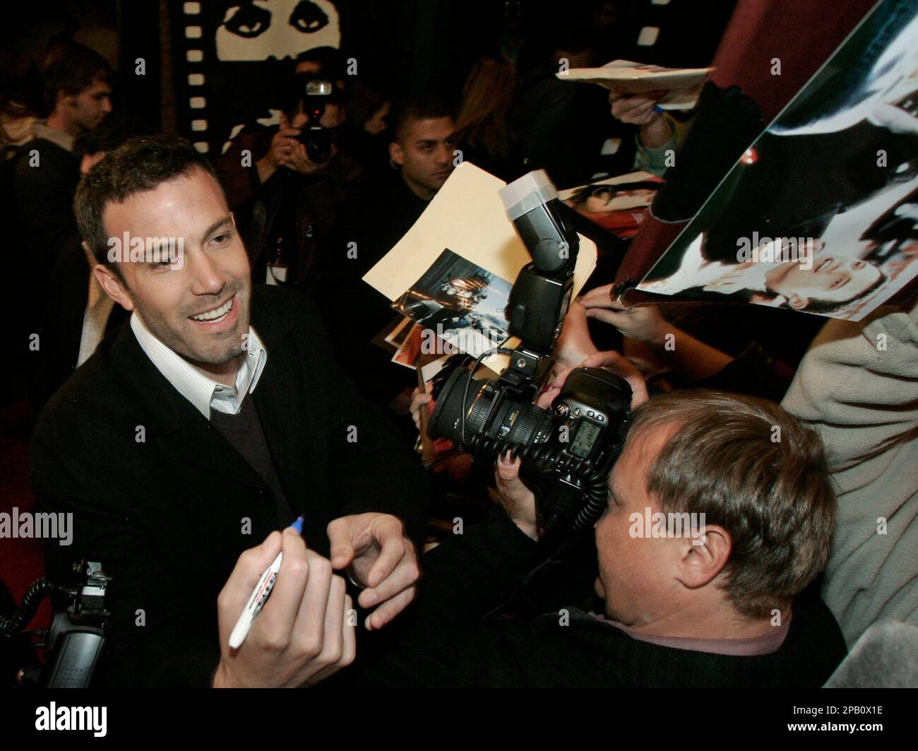 "Gone Baby Gone" director Ben Affleck, left, signs autographs at the ...