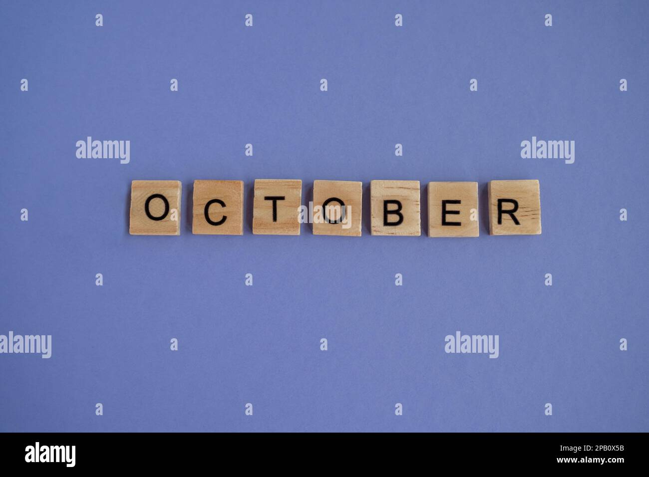 The name of the month October is written on wooden cubes isolated. Top ...