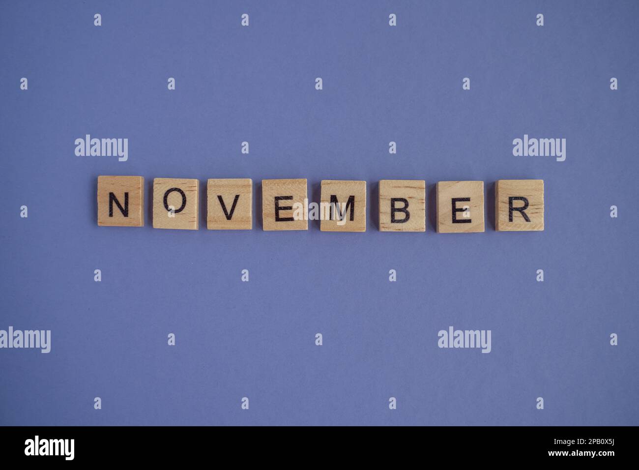The name of the month of November is written on wooden cubes isolated ...
