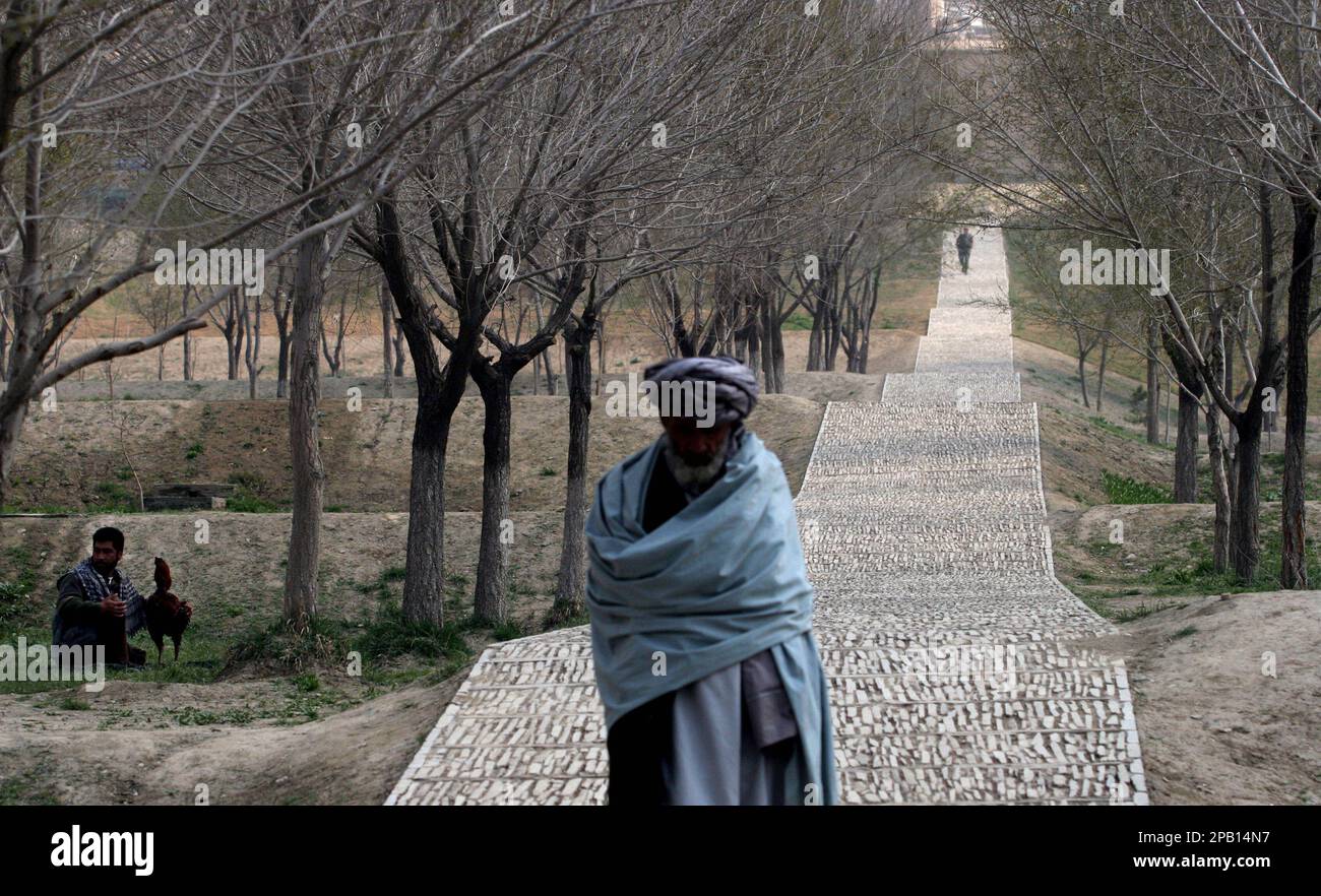For Immediate Release File An Afghan Man Left Waits With His