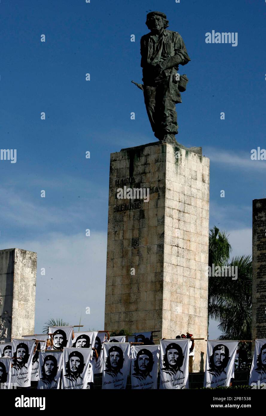 Students hold banners with the image of late Argentine-born Cuba's ...