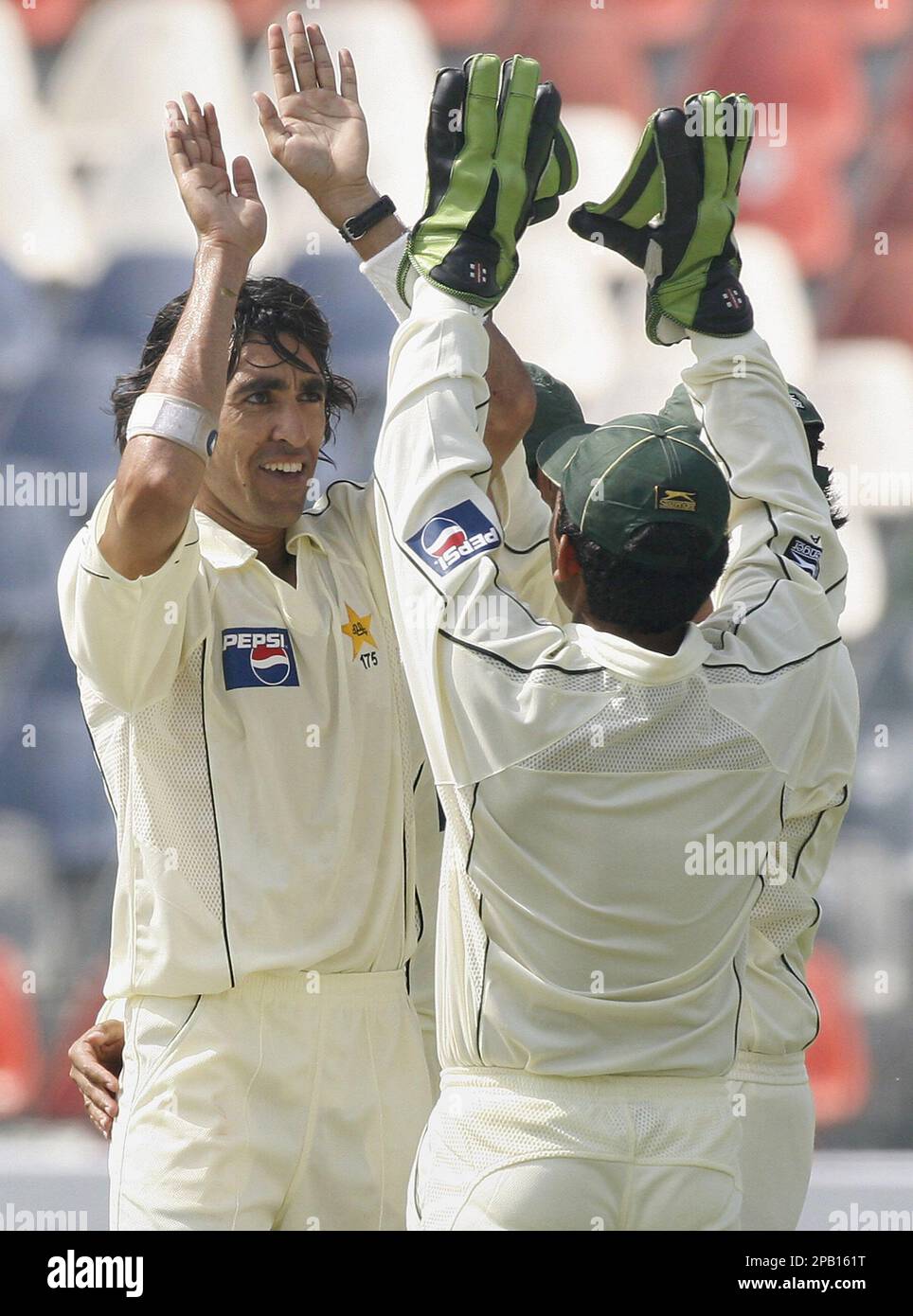 Pakistans pacer Umar Gul, left, celebrates with teammate Kamran Akmal ...
