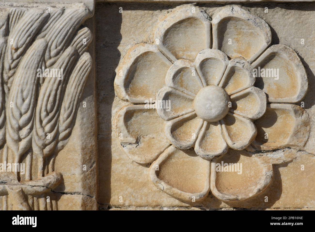 Ancient marble sculpted flower rosette and triune wheat at the ...