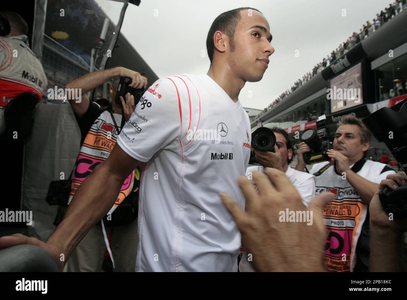 British driver Lewis Hamilton is surrounded by photographers in the ...