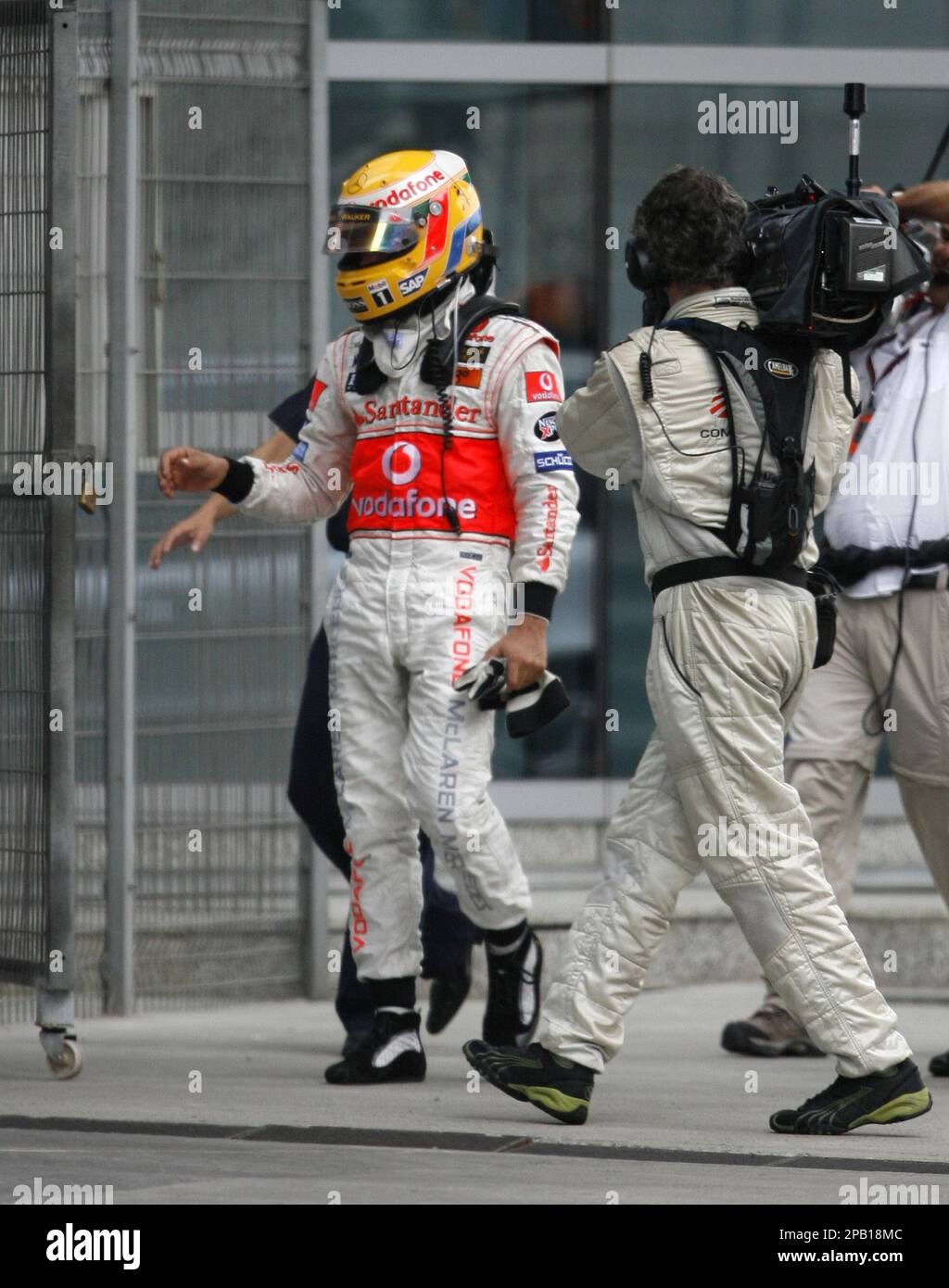 British driver Lewis Hamilton walks back to the McLaren-Mercedes garage ...