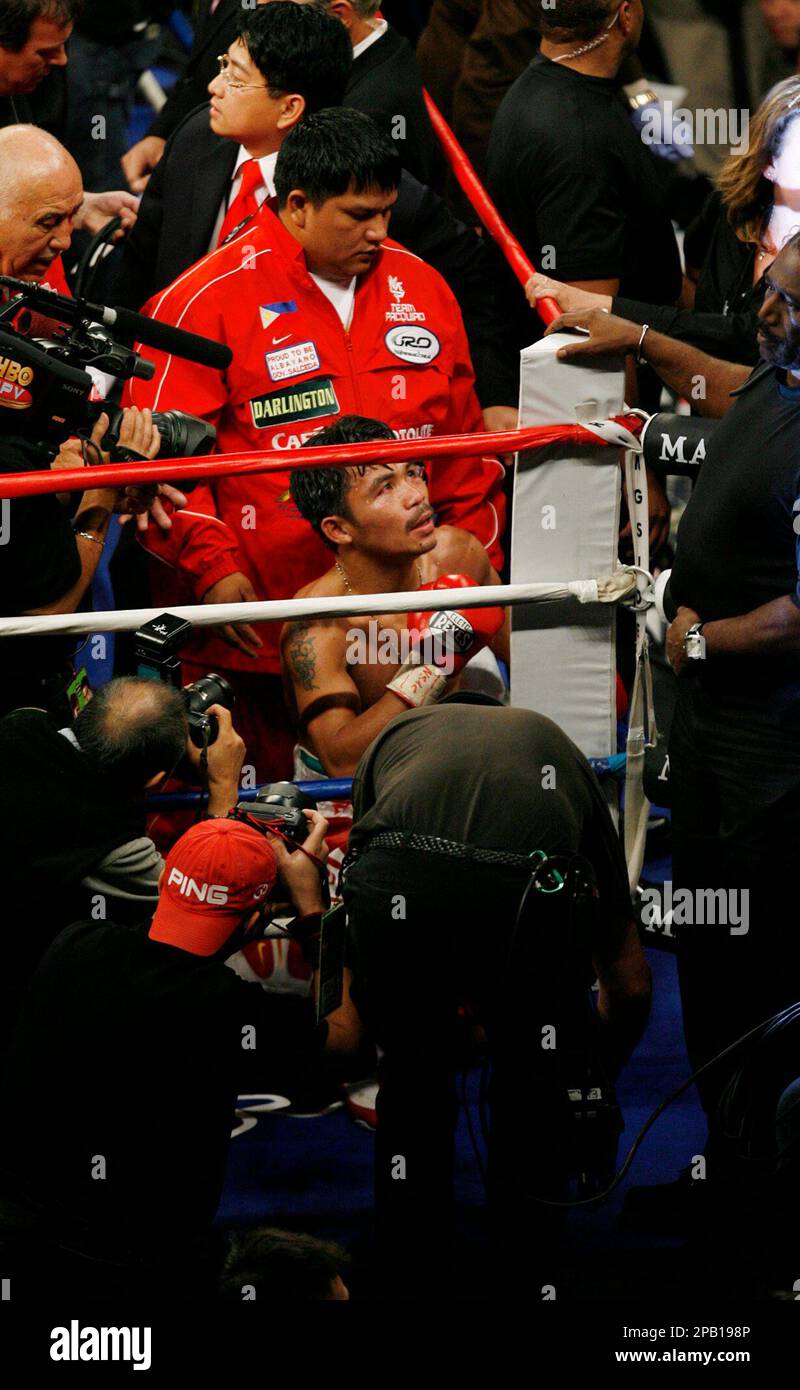 Manny Pacquiao of the Philippines takes a moment following his victory ...