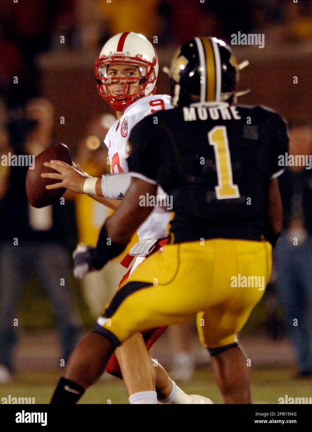 Nebraska quarterback Sam Keller, left, looks to pass as Missouri safety ...