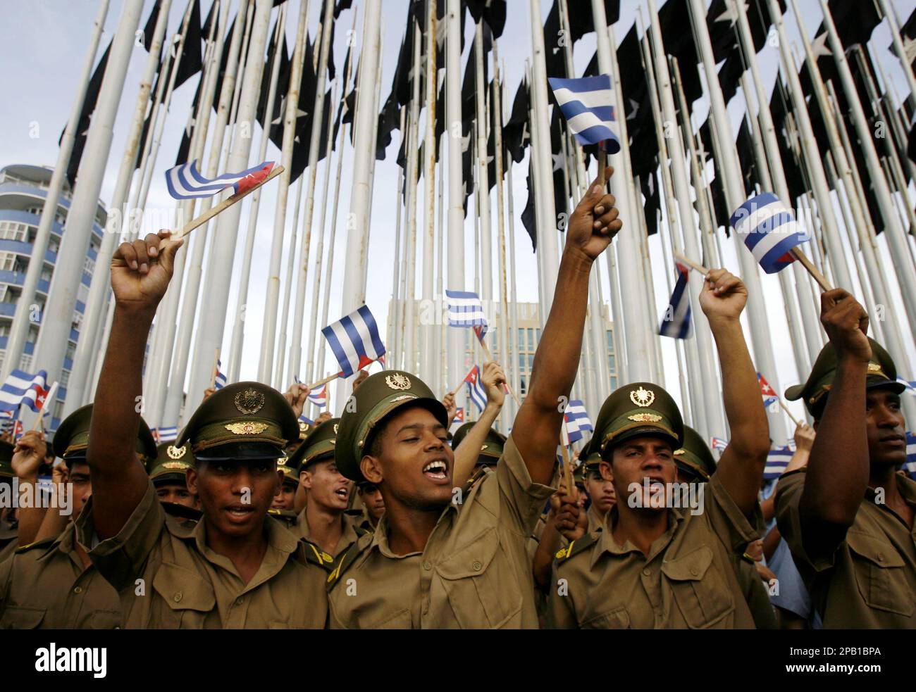 Cuban military cadets wave miniature Cuban flags as they cheer outside ...