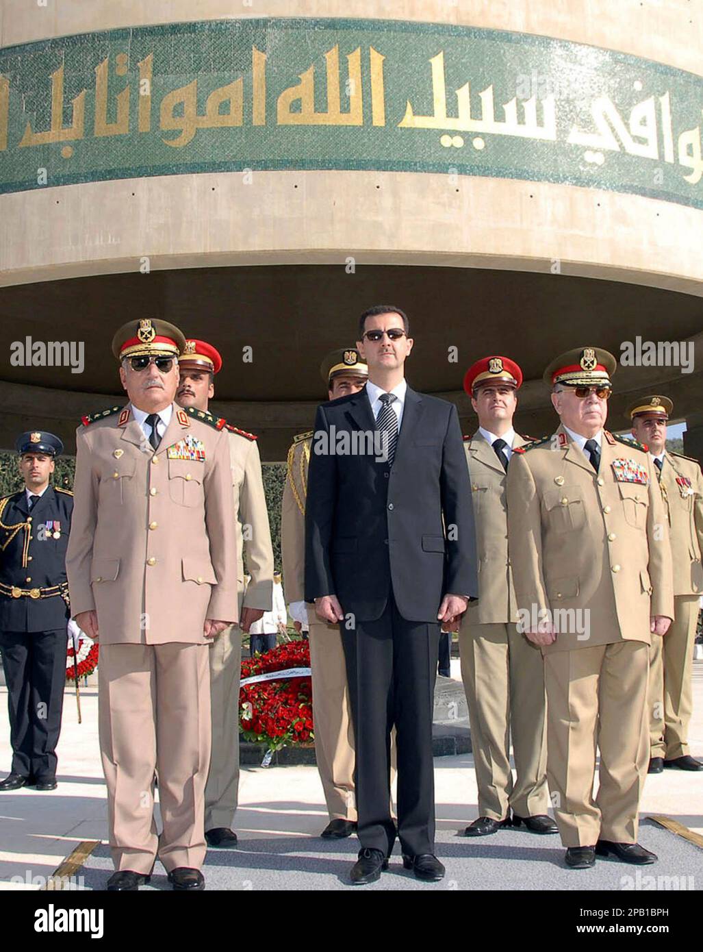 Syrian president Bashar Assad, center, General Hassan Turkmani, right ...