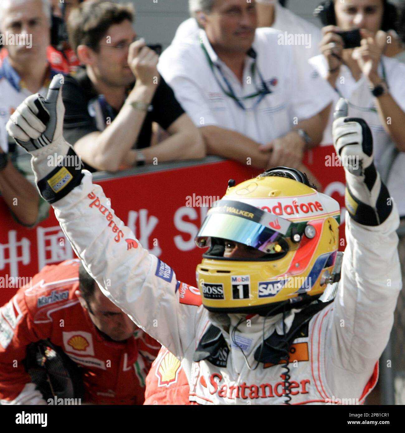 British McLaren-Mercedes driver Lewis Hamilton shows thumbs-up signs ...