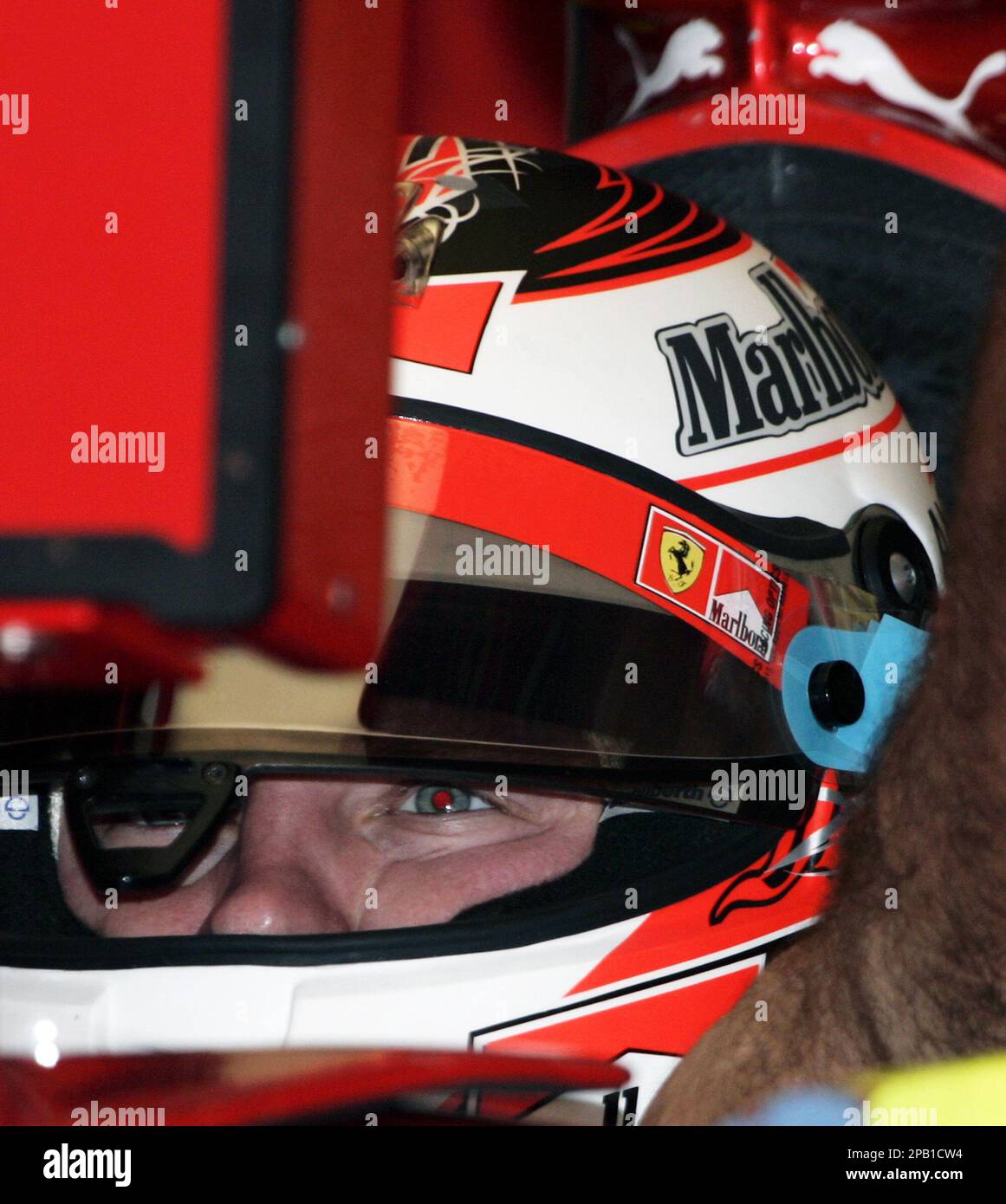 Finnish Kimi Raikkonen sits in the cockpit of his Ferrari at the team's ...