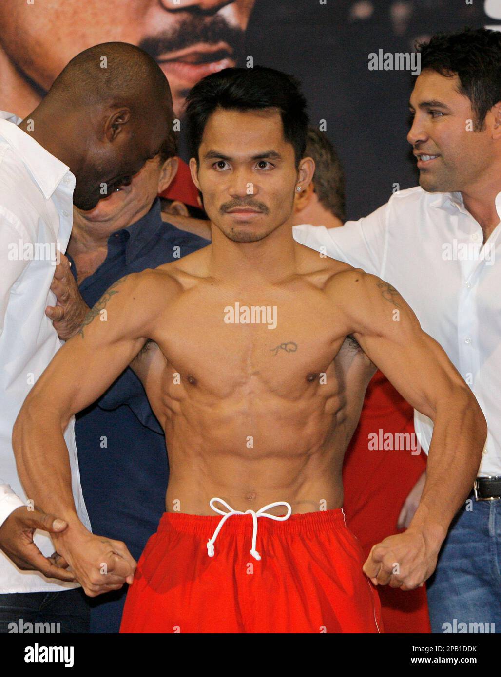 Boxer Manny Pacquiao, of the Philippines, flexes his muscles during an ...