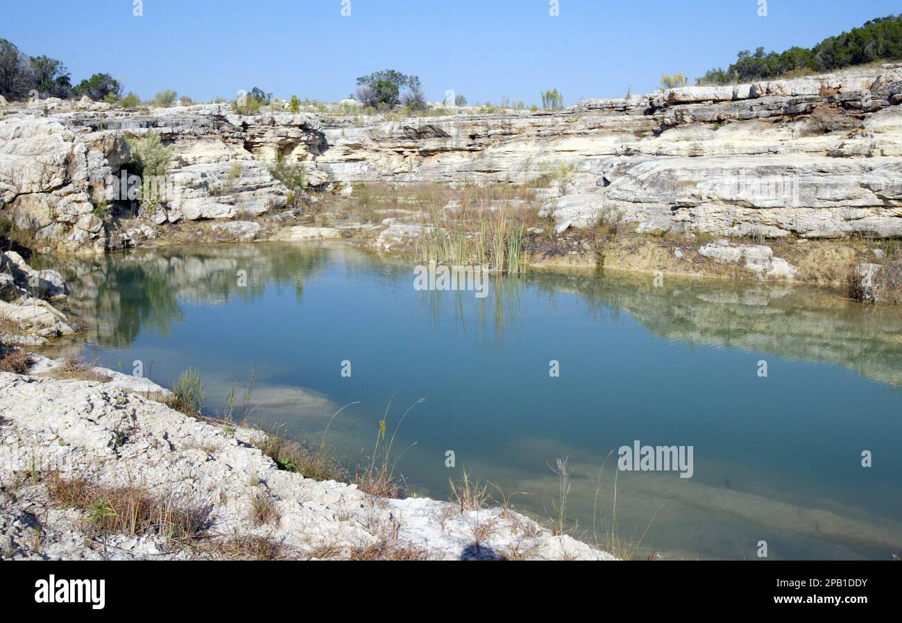 A pool of water in the gorge below the spillway of Canyon Lake in ...