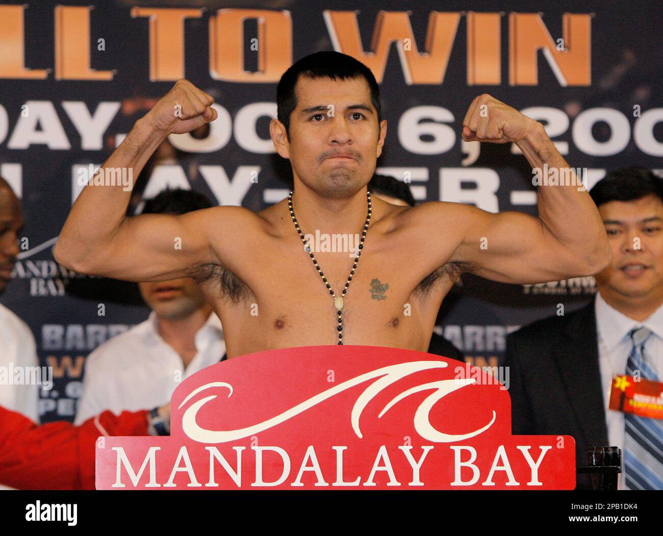 Boxer Marco Antonio Barrera, of Mexico, flexes his muscles as he weighs ...
