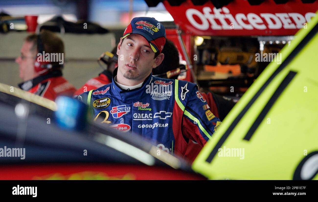 Kyle Busch looks over his car in the garage area during practice for ...