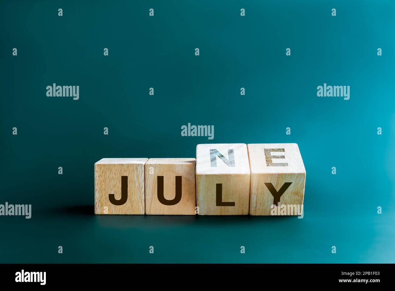 Changing the month of mid of the year. Flipping wooden cube blocks for ...