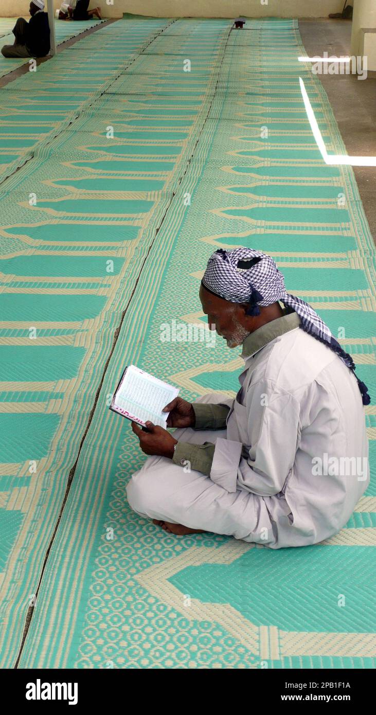 A Kenyan Muslim recites from the Quran while at a mosque during Islam's ...