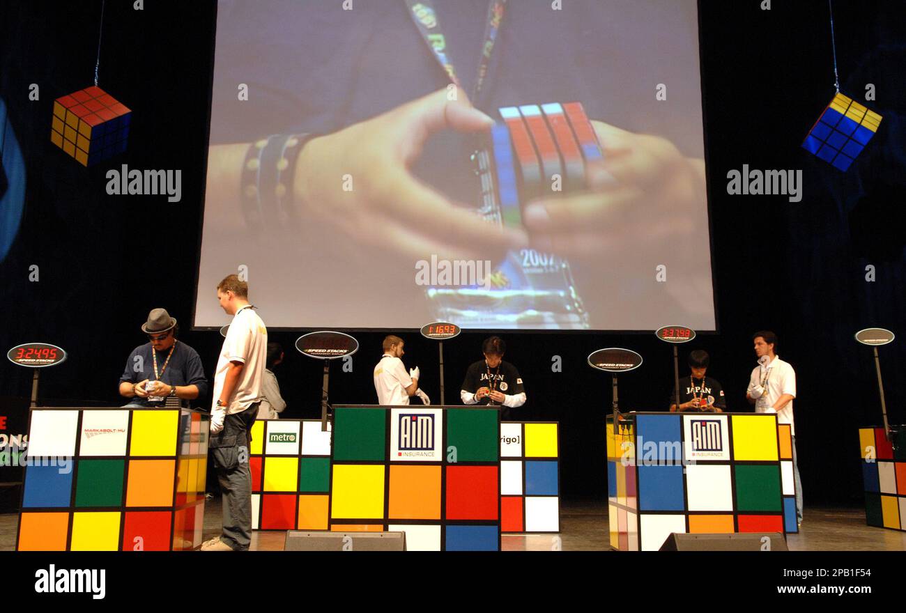 Players from Sweden solve a Rubik's cube during the qualification ...