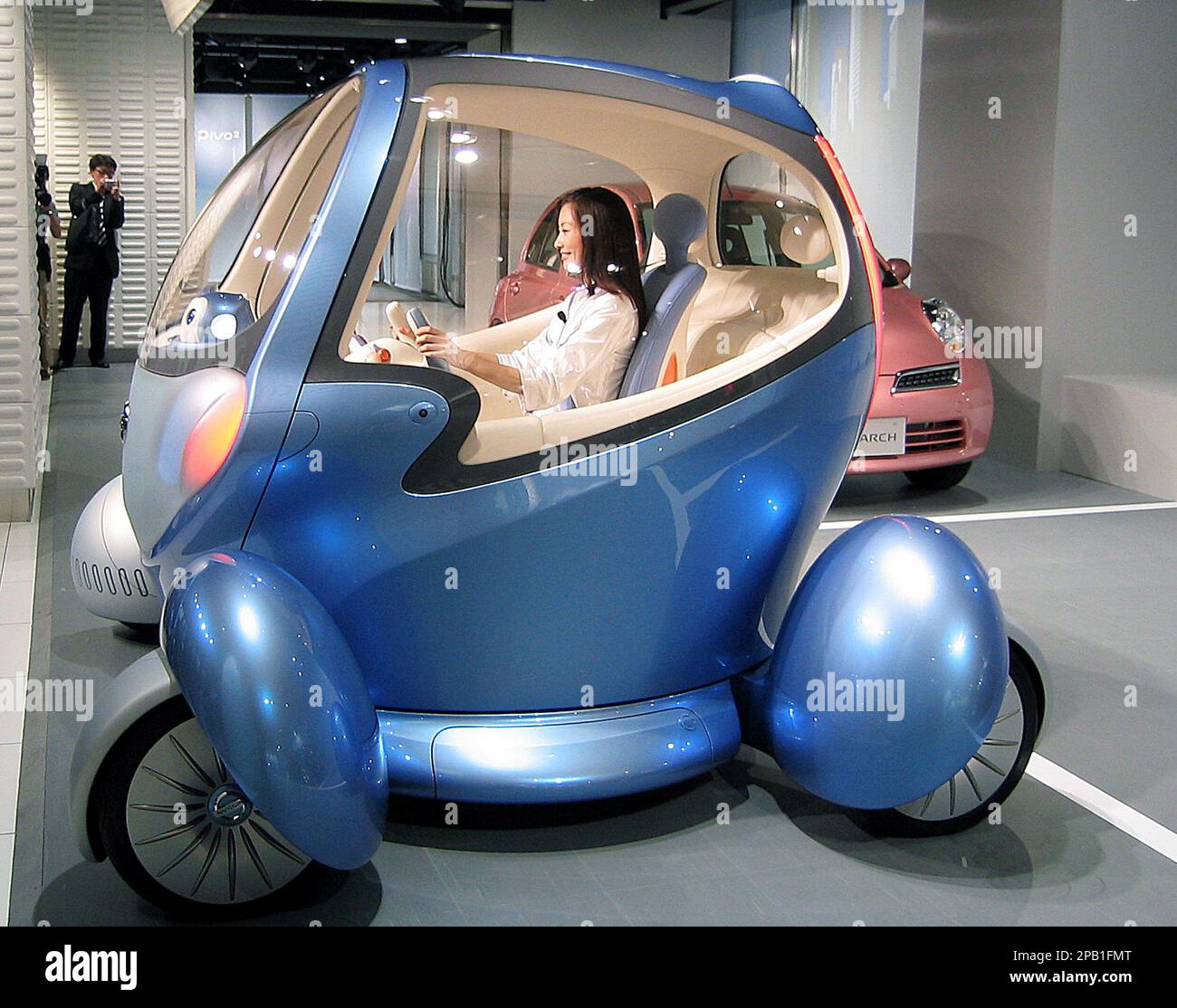 A Nissan Motor Co. staff drives the Japanese auto maker's electric ...