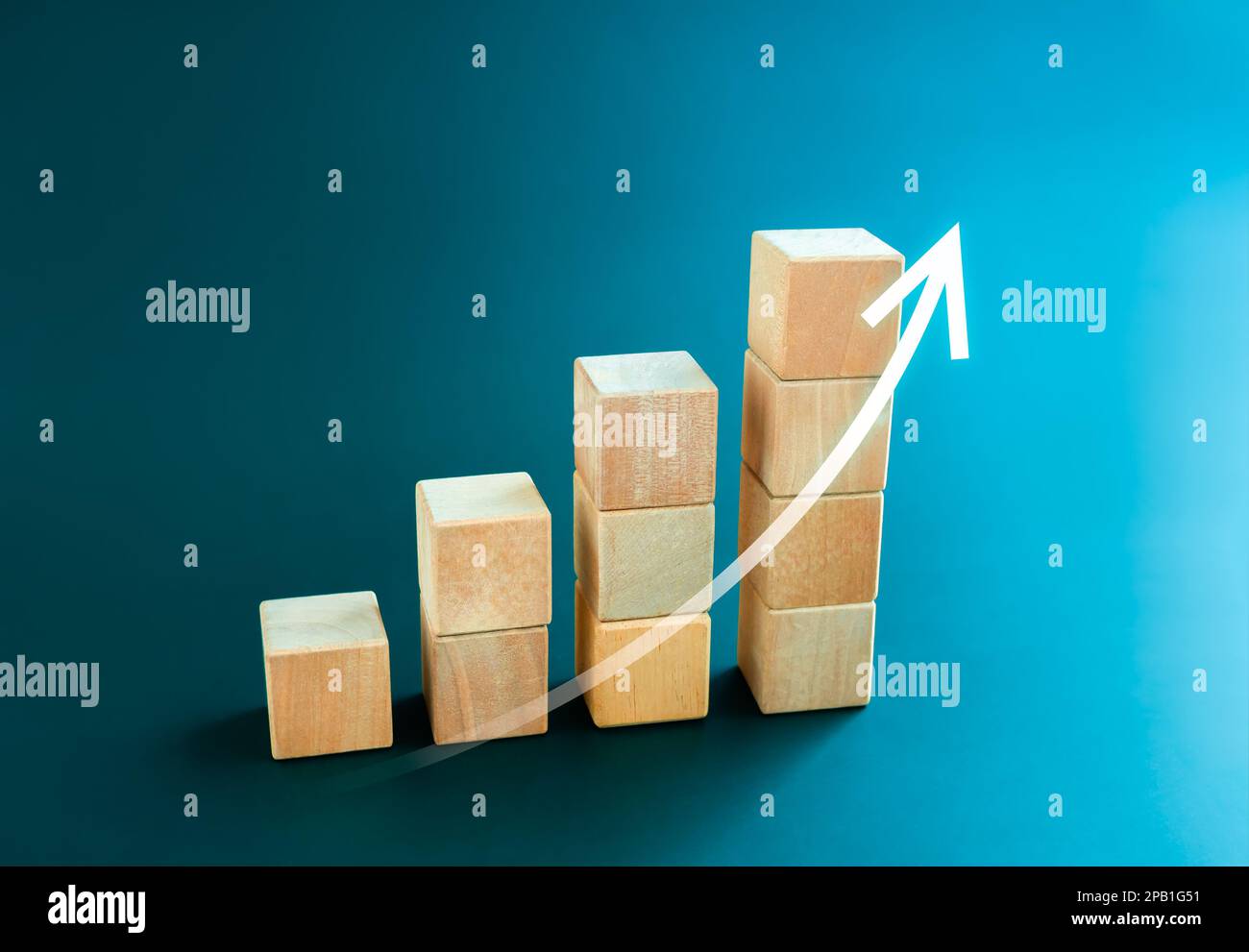 White rising up arrow draw on wooden cube blocks bar graph chart steps ...