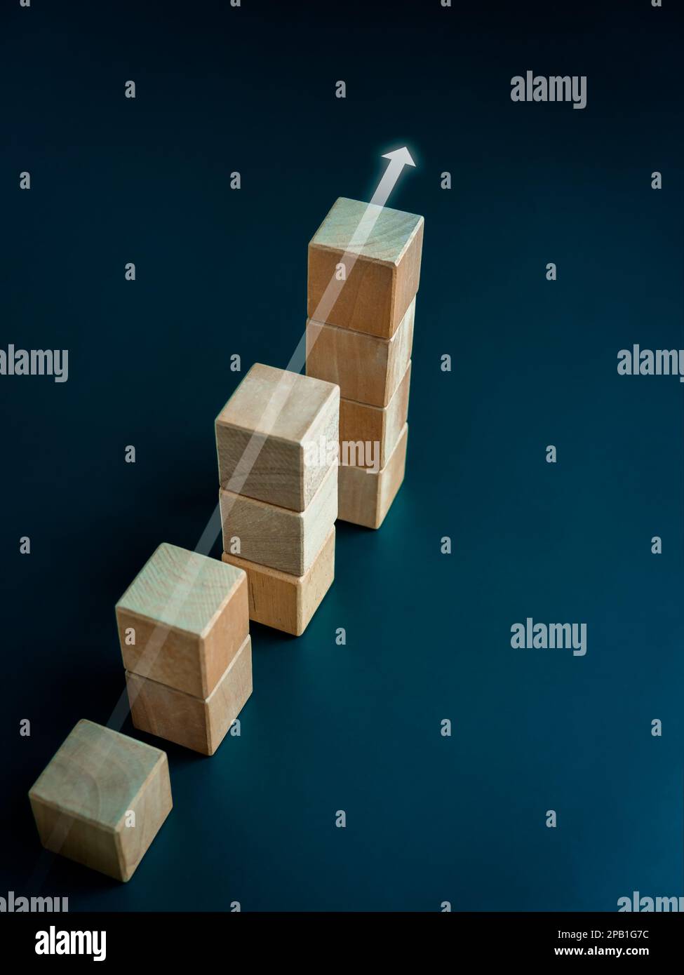 Straight arrow rising on wooden cube blocks, bar graph chart steps on ...