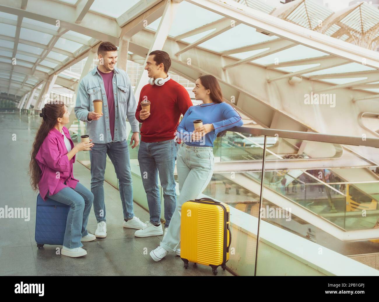 Four Young People Traveling Drinking Coffee In Modern Airport Indoors ...